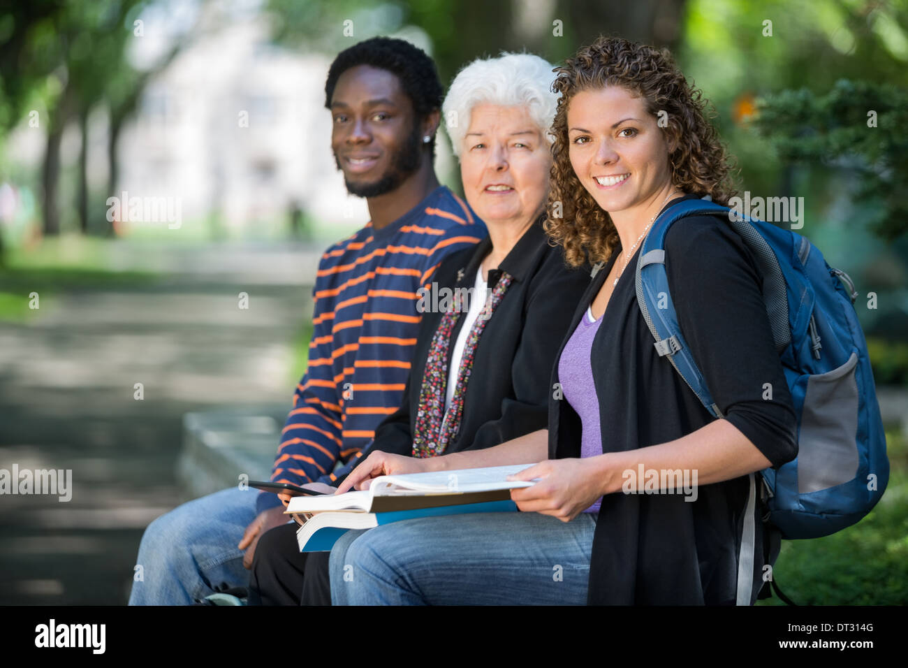 Confident University Students Sitting On Campus Stock Photo - Alamy