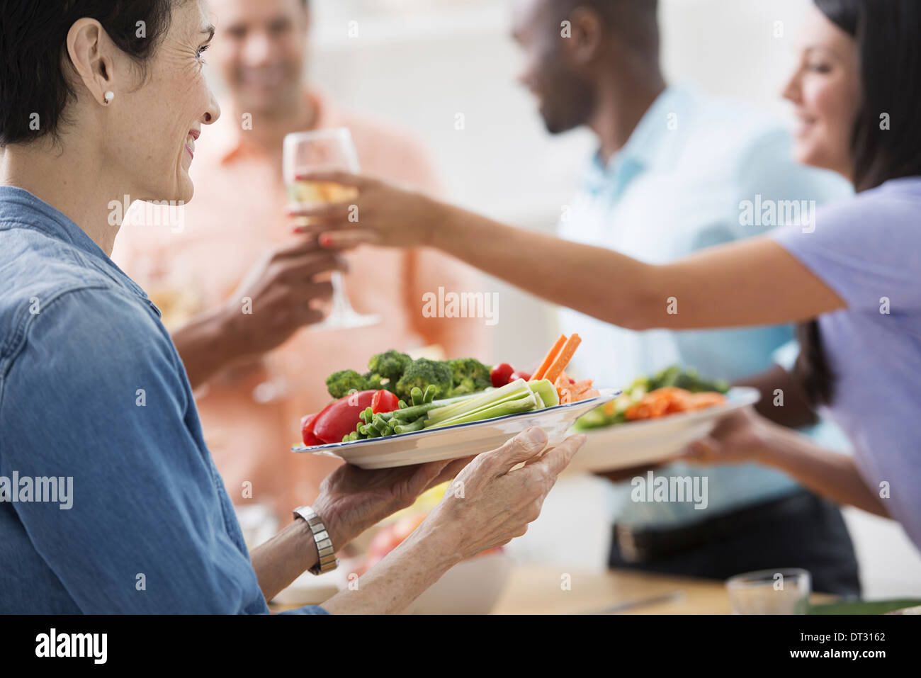 A working lunch a salad buffet A woman holding out a glass of wine and ...