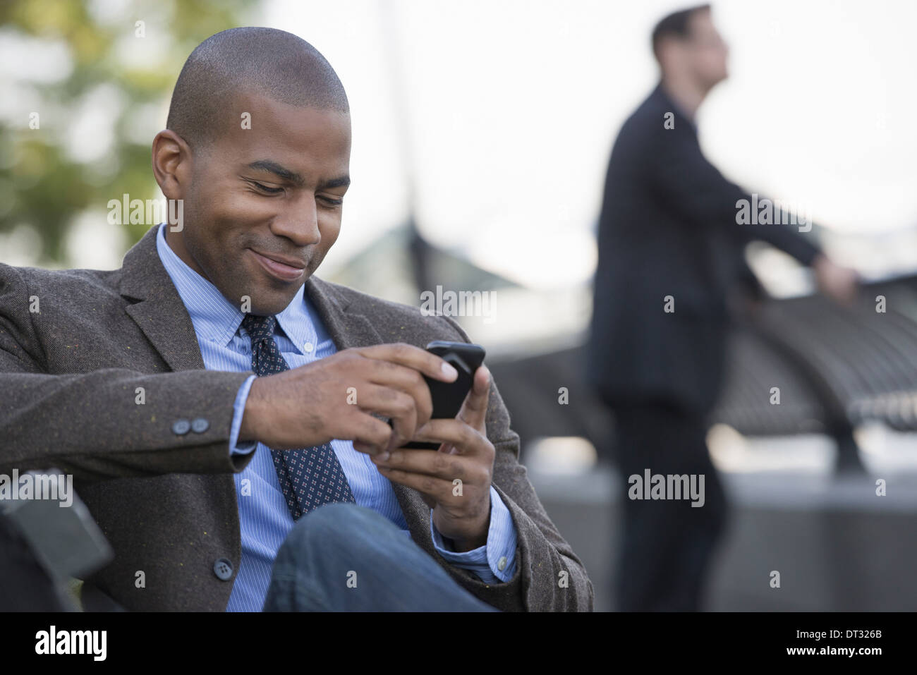 Smart dressed man sitting down hi-res stock photography and images - Alamy
