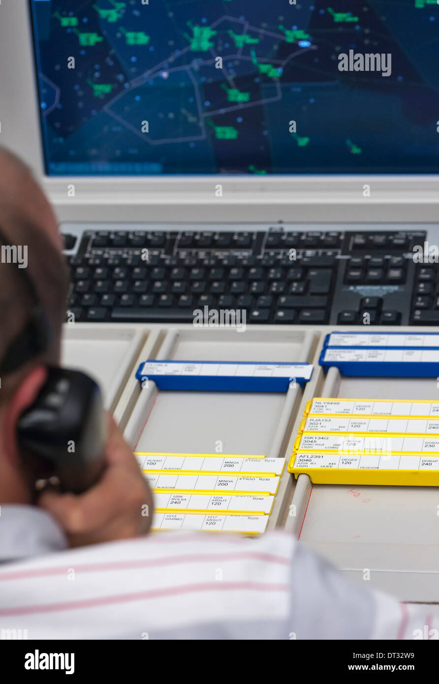An air traffic controller in the air traffic control centre of ...