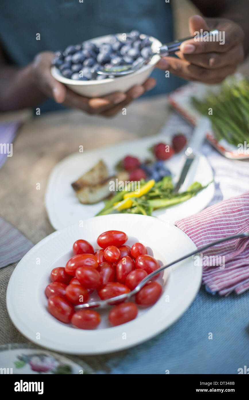 Parents and children helping themselves to fresh fruits and vegetables ...
