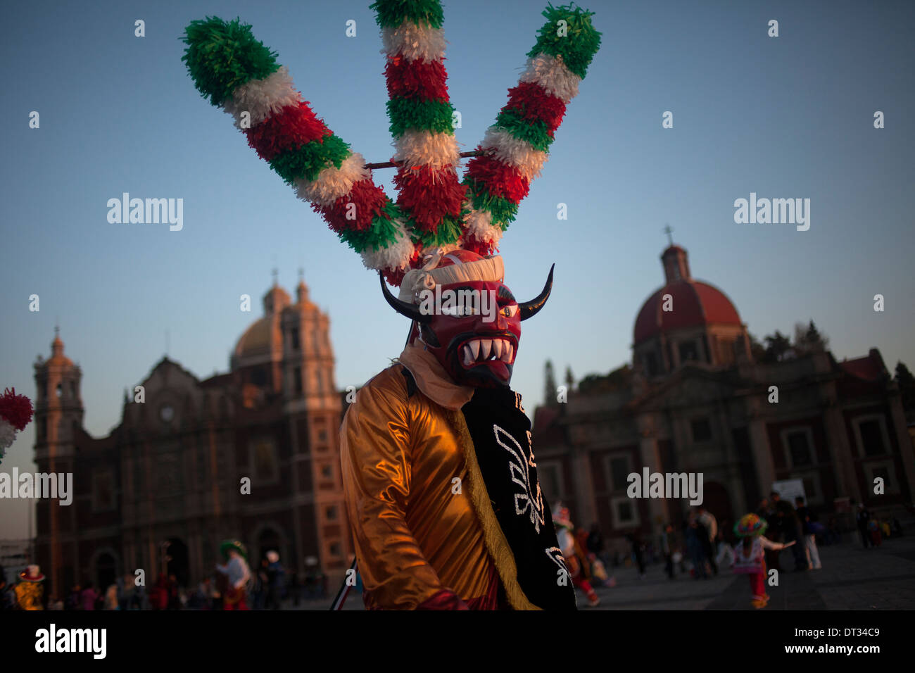 A dancer dressed as a red devil, dances the Danza de los Santiagos at ...
