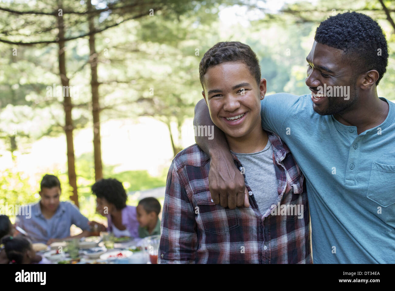 A man and a young boy looking at the camera Stock Photo - Alamy