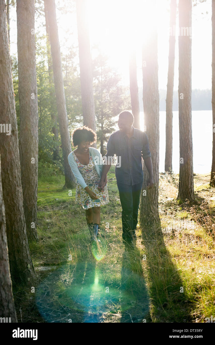 A happy couple in a shady spot in woodland in summer Stock Photo - Alamy