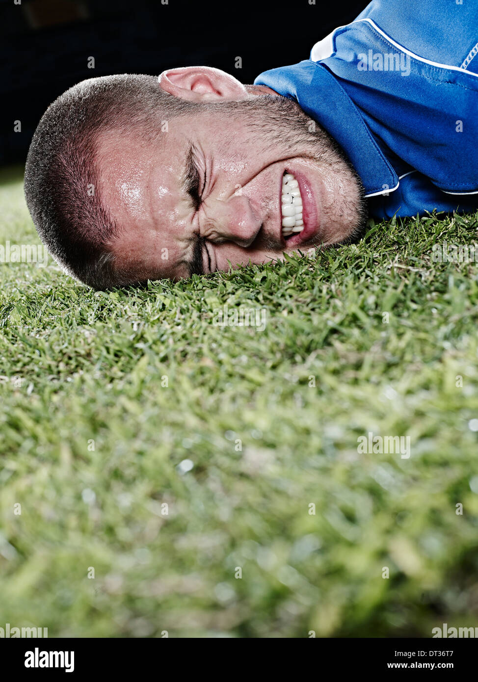 Soccer player falling on field Stock Photo - Alamy