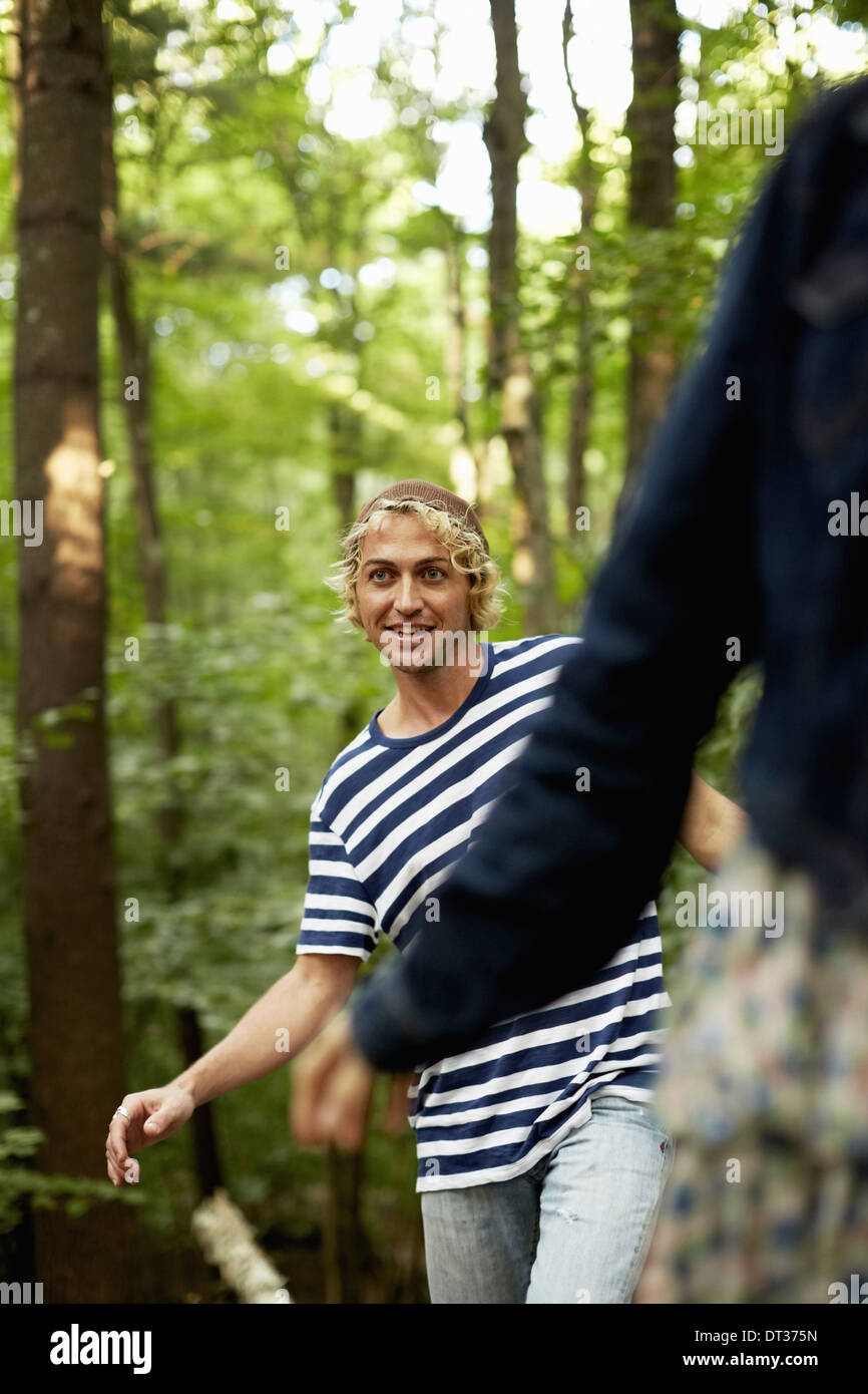 Two people walking along a fallen tree trunk Stock Photo - Alamy
