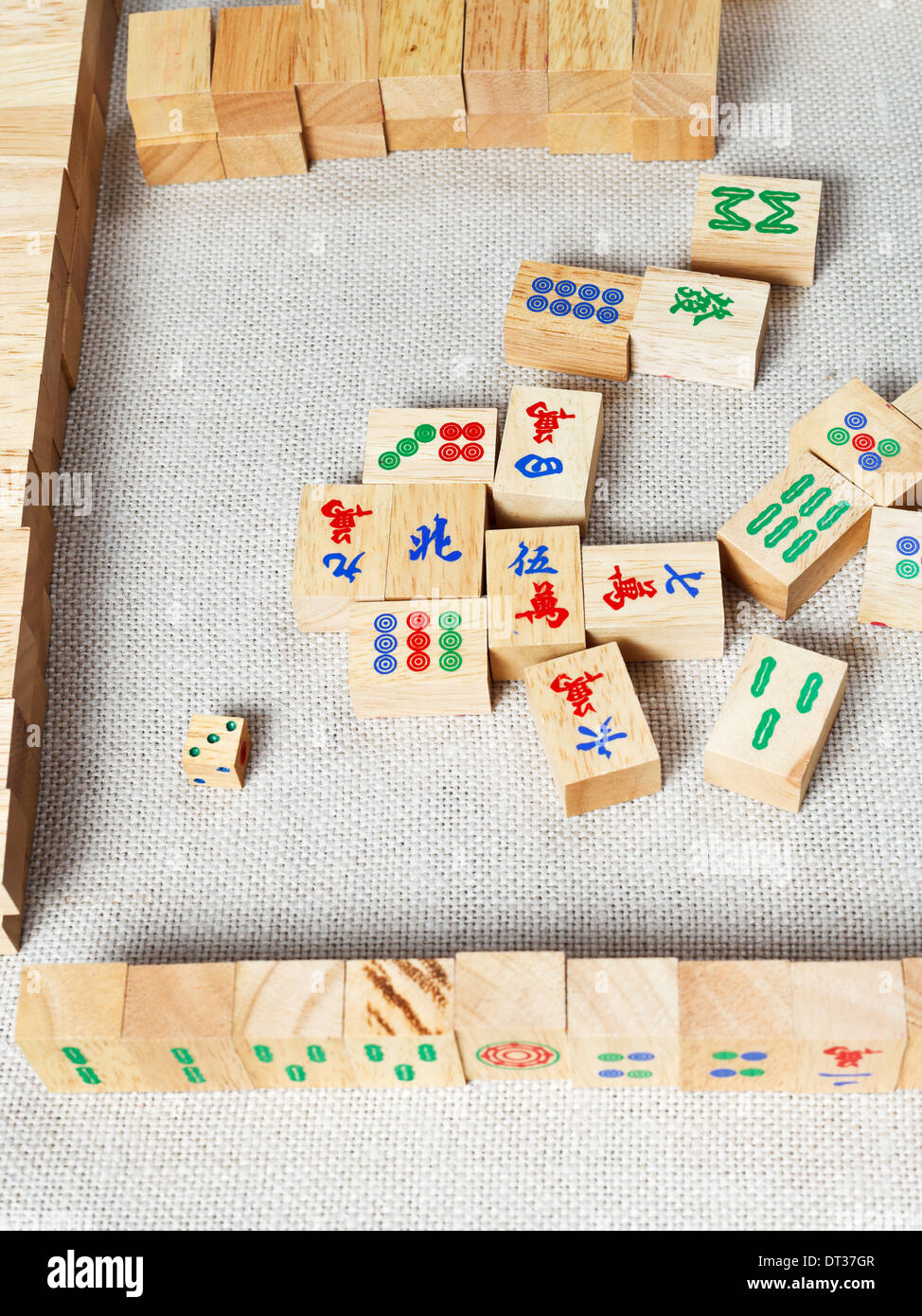 above view of playing field of mahjong board game on textile table ...