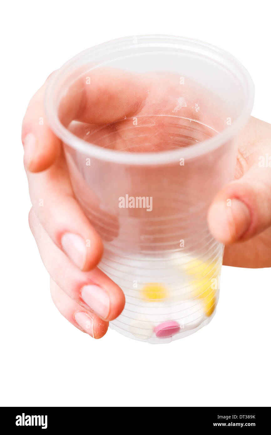 plastic cup with dose of tablets in hand isolated on white background ...