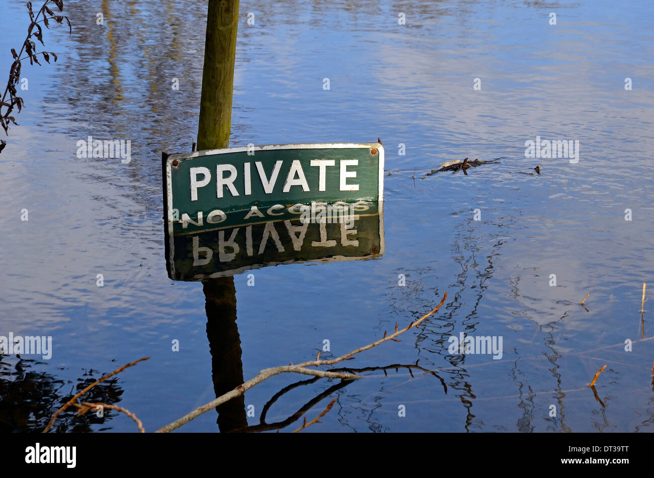 Partly submerged "Private No Access" sign in flood water from an ...