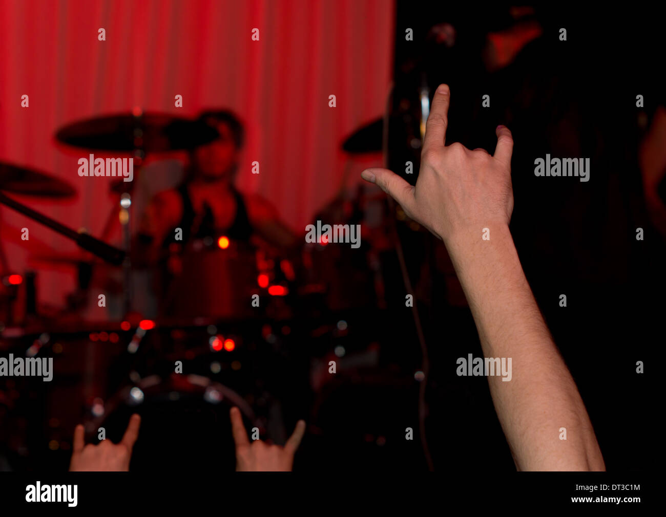Audience at a rock concert giving the horns sign Stock Photo - Alamy