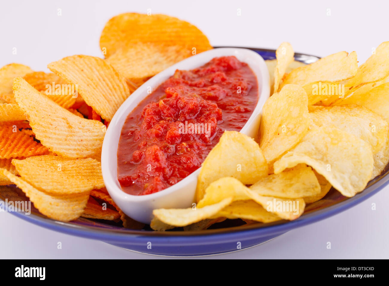 Potato chips and red sauce isolated on gray background Stock Photo - Alamy