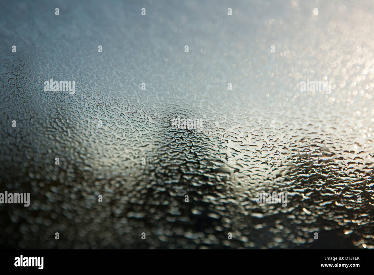 Frozen car windscreen defrosting, ice is melting Stock Photo - Alamy