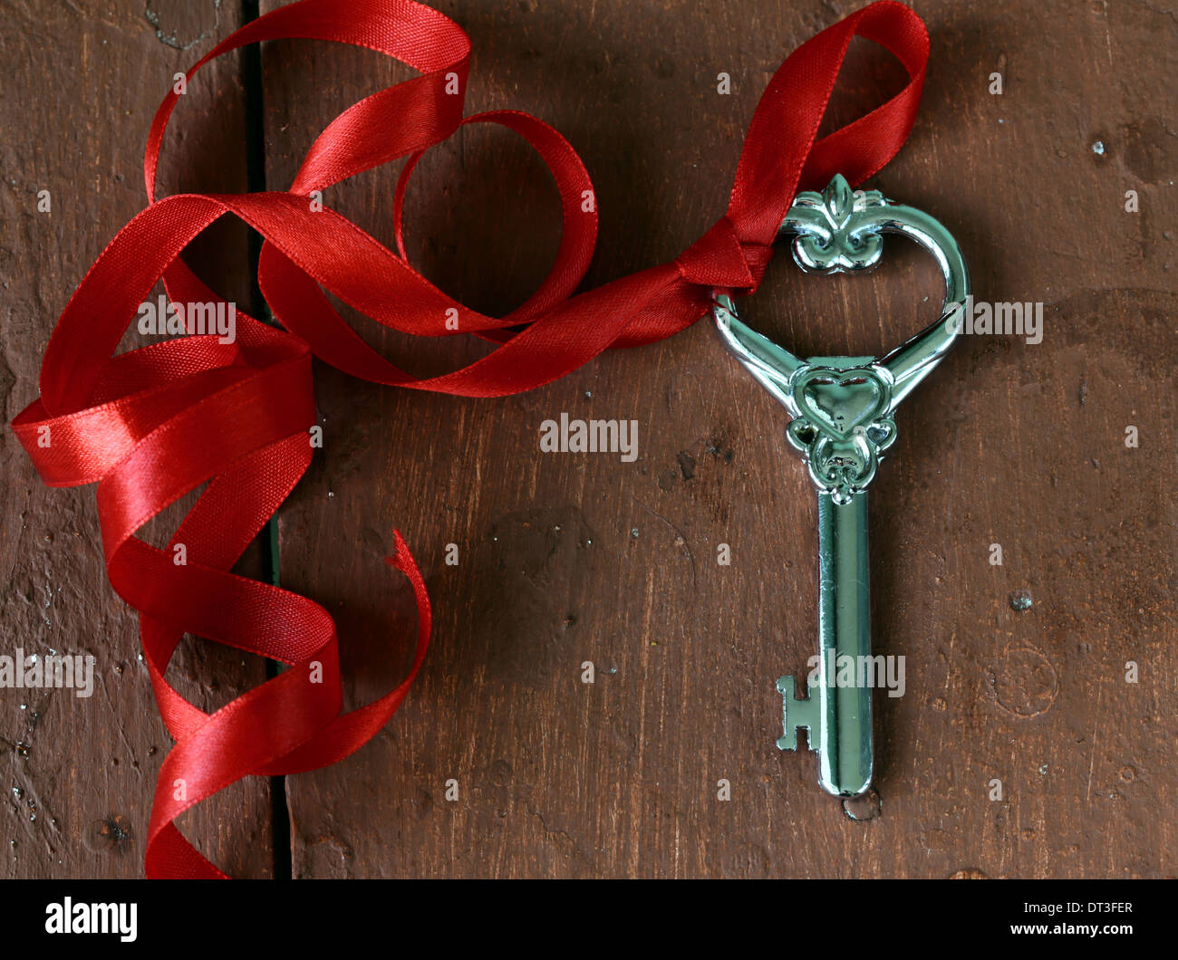 Vintage key with a festive beautiful red ribbon Stock Photo - Alamy