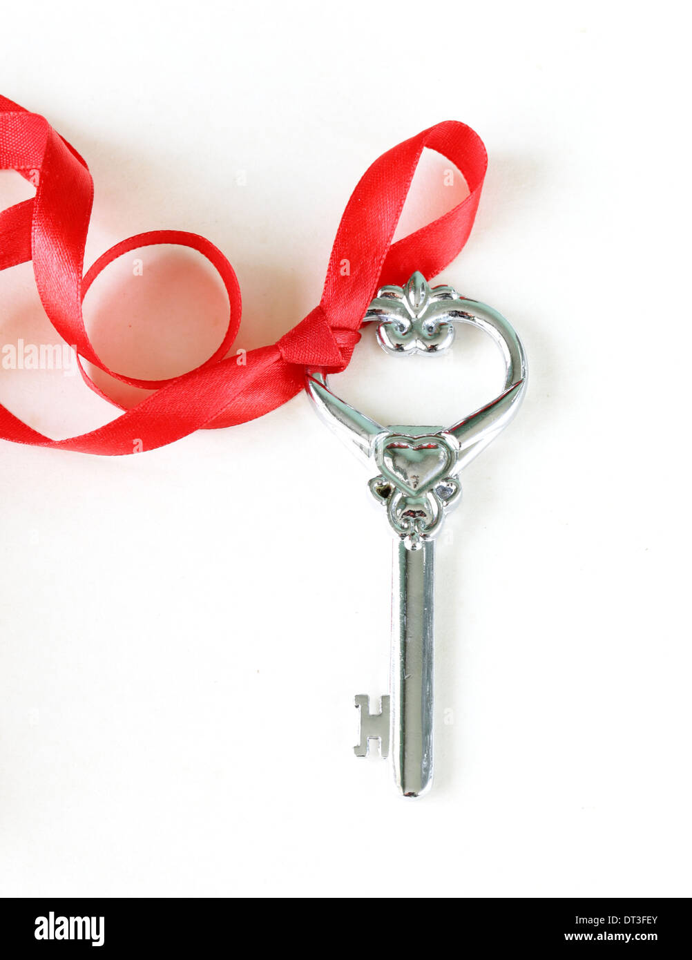 Vintage key with a festive beautiful red ribbon Stock Photo - Alamy