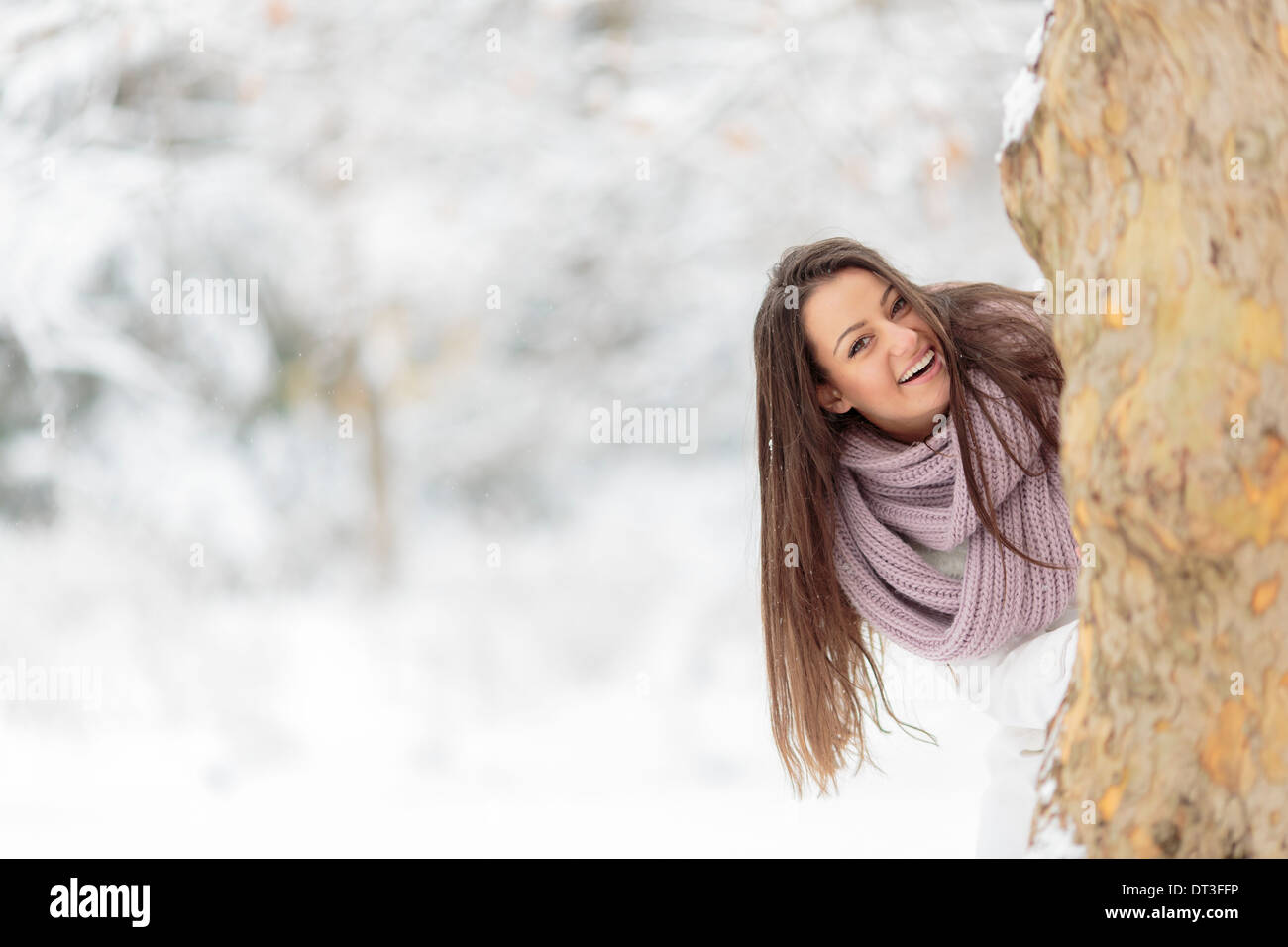 Girl winter tree hiding hi-res stock photography and images - Alamy