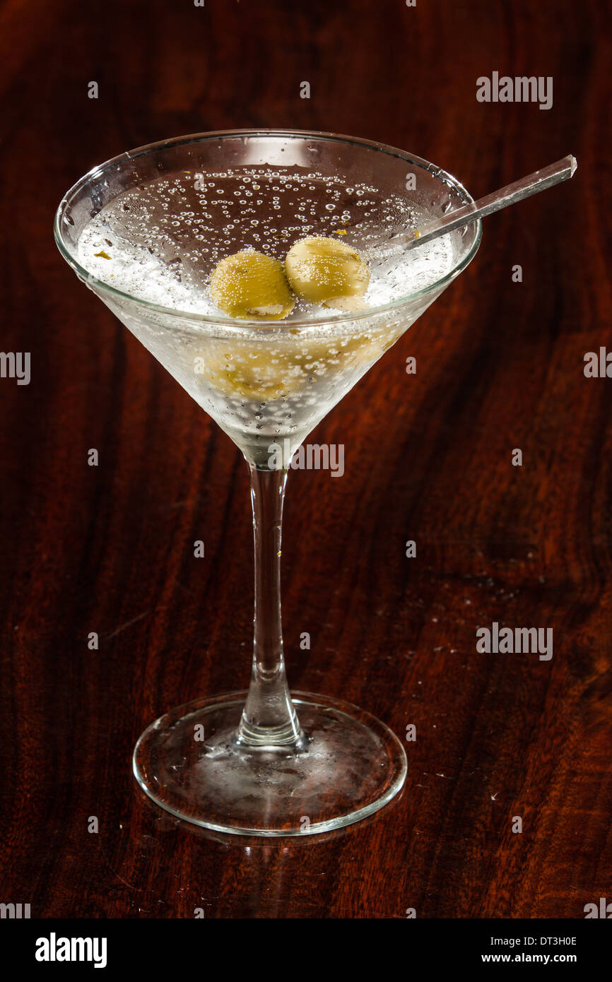 Garlic stuffed martini olives garnishing a sparking vodka martini Stock ...