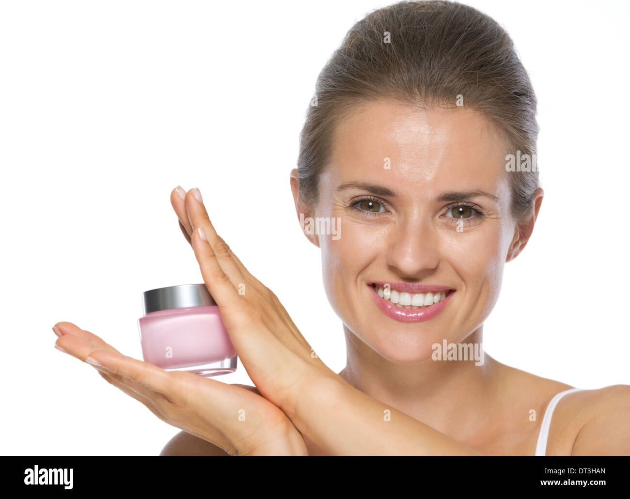 Happy young woman showing creme Stock Photo - Alamy