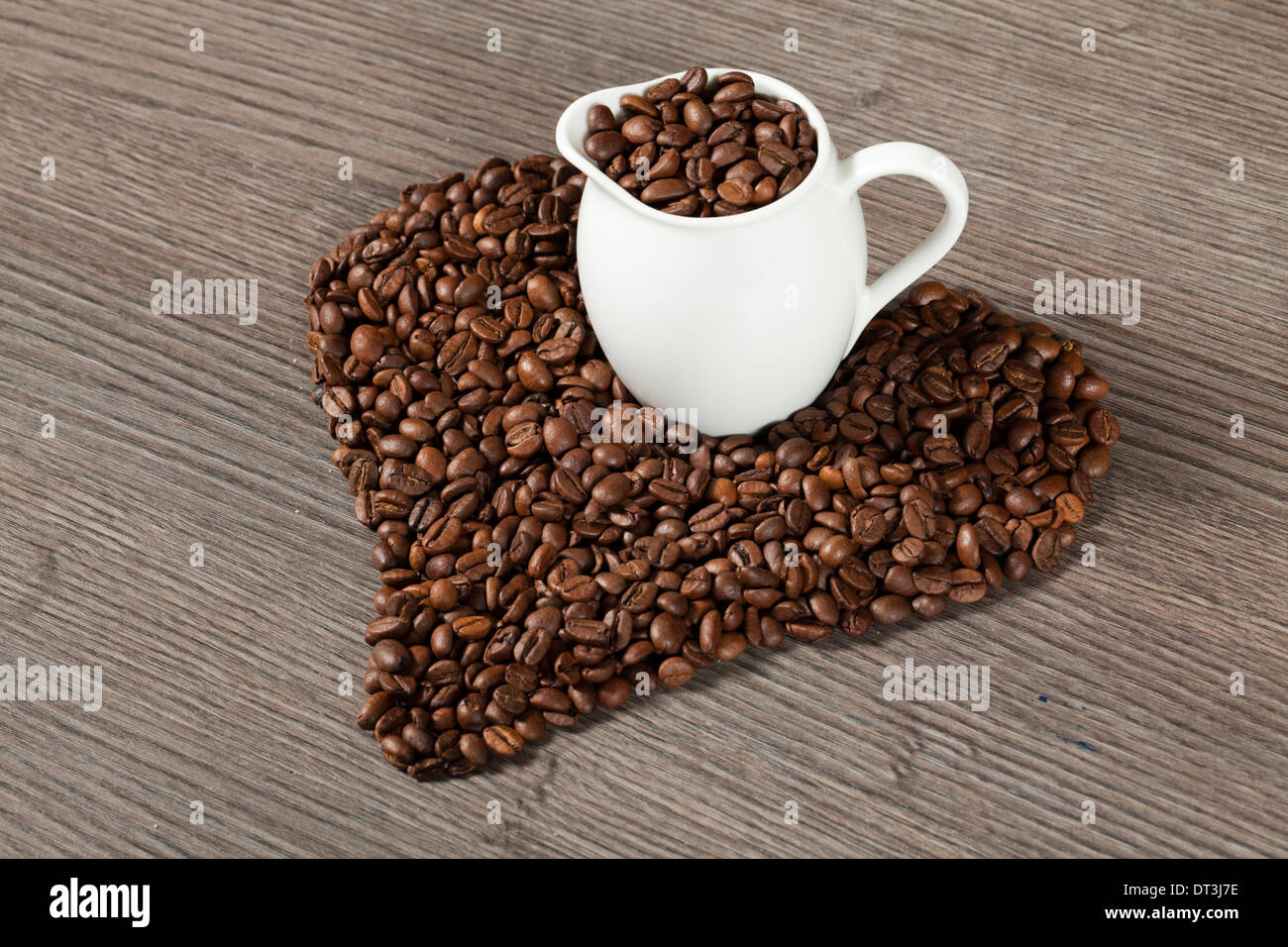Coffee beans on wooden tale hart shape Stock Photo - Alamy