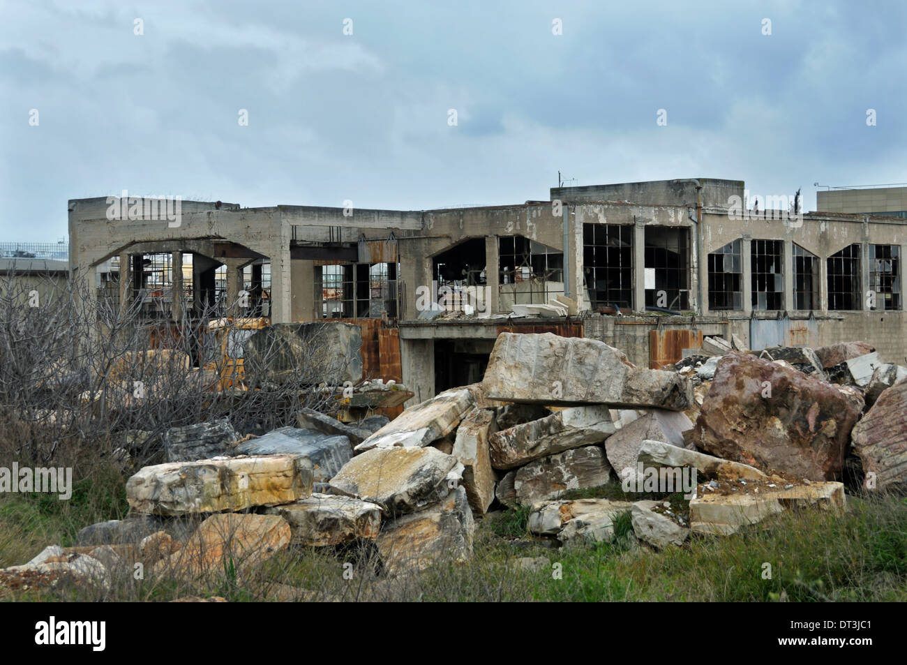 Abandoned marble processing factory exterior and cloudy sky. Industrial ...