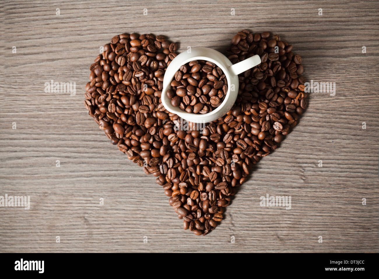 Coffee beans on wooden tale hart shape Stock Photo - Alamy