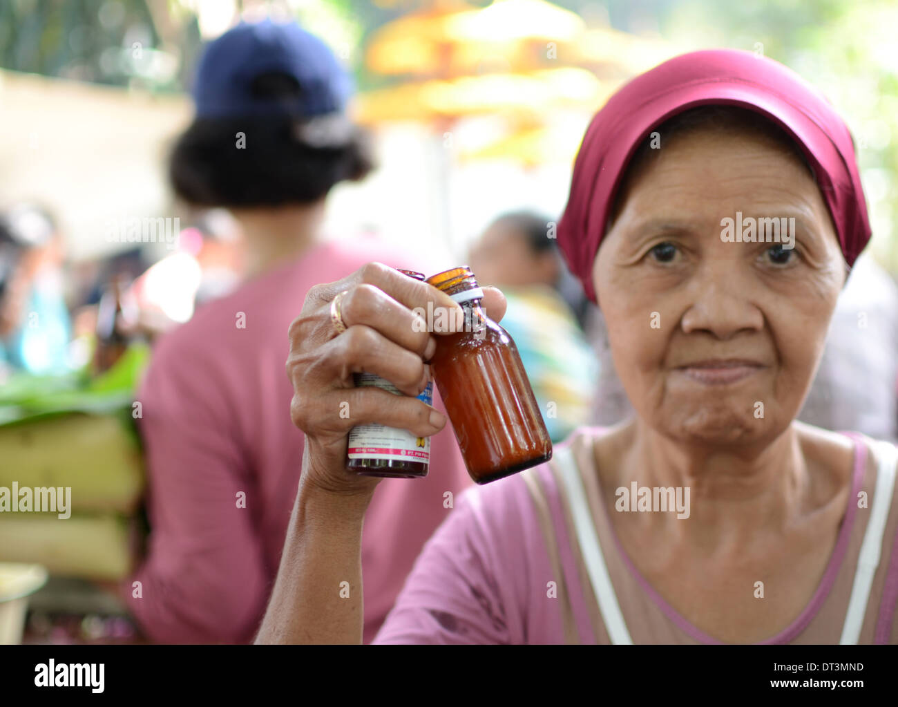A woman drinking traditional liquor called Badek in a ritual pilgrimage ...