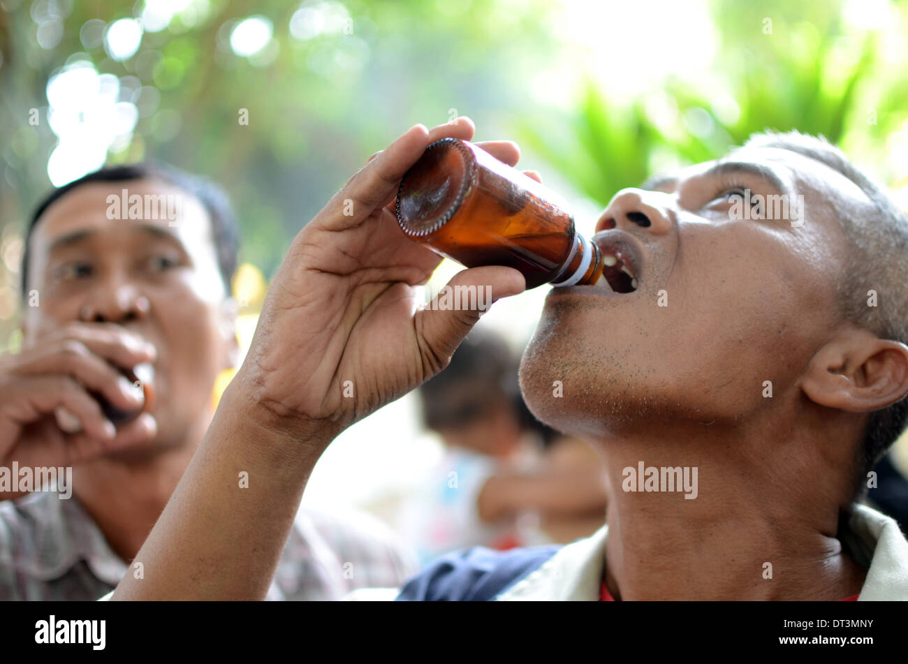 A man drinking traditional liquor called Badek in a ritual pilgrimage ...