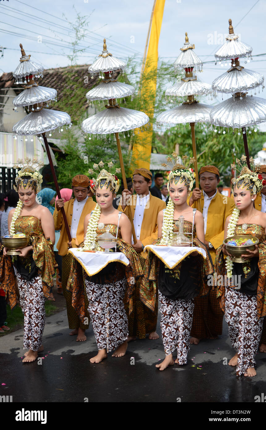 Liquor offerings to ancestors paraded around Doko village. Indonesia is ...