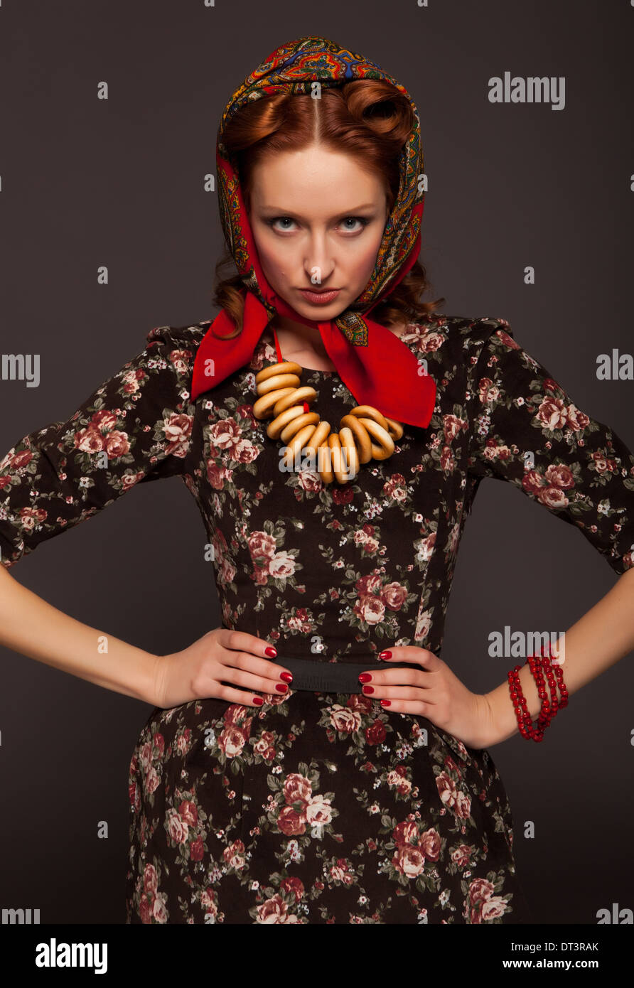 Girl in Russian style posing in red kerchief and bagels on the neck ...