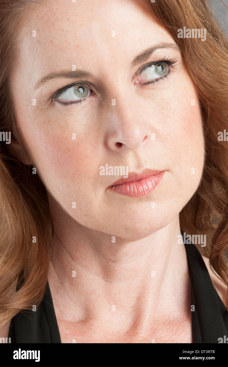 Beautiful mature woman looking up Stock Photo - Alamy