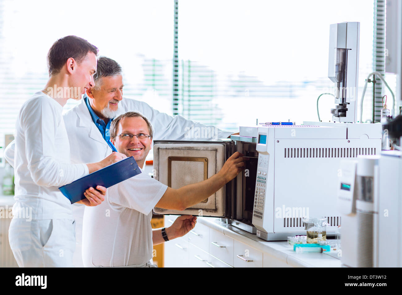 Team of researchers carrying out experiments in a lab (shallow DOF ...
