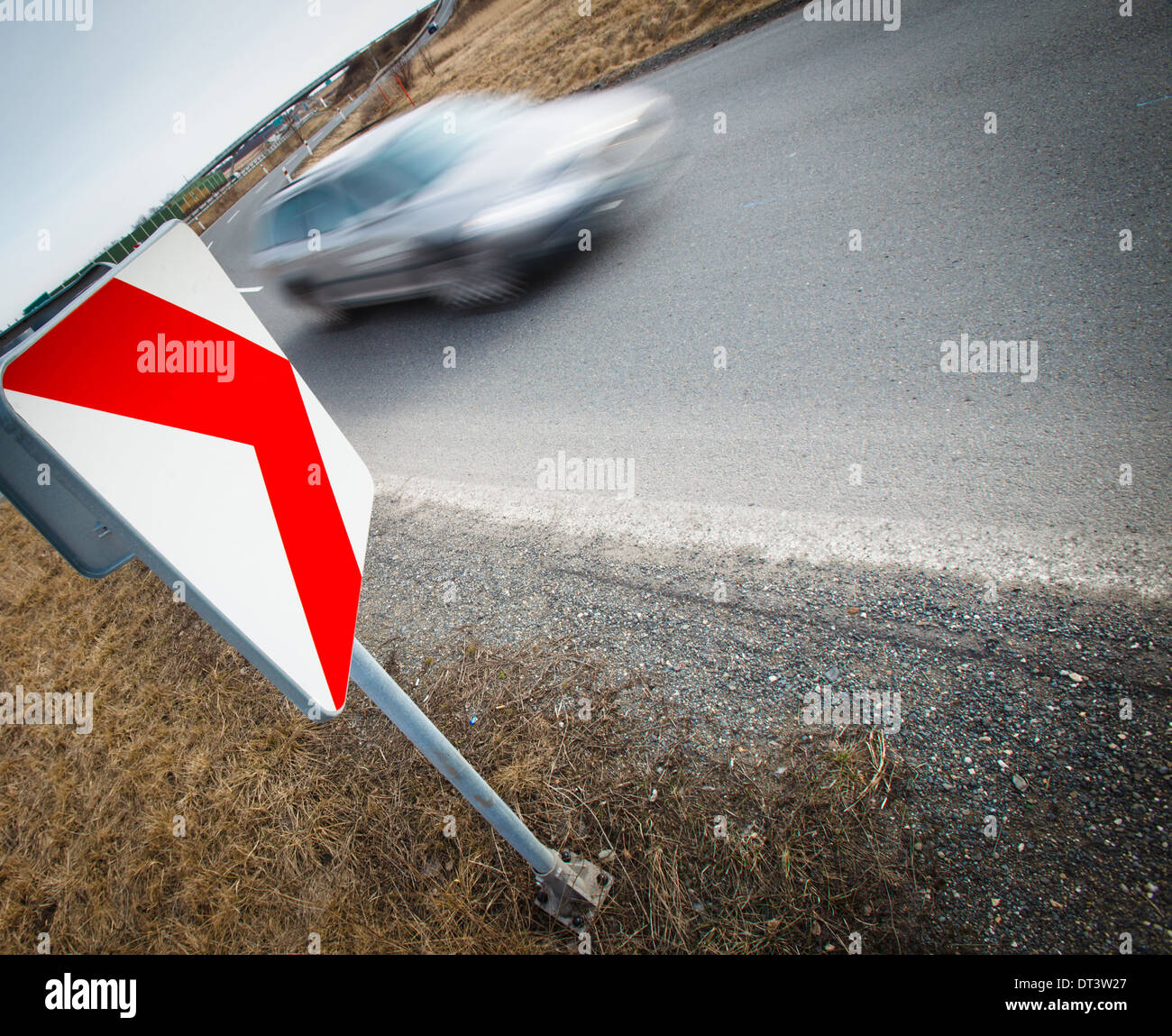 Traffic concept: car driving fast through a sharp turn (motion blur is ...