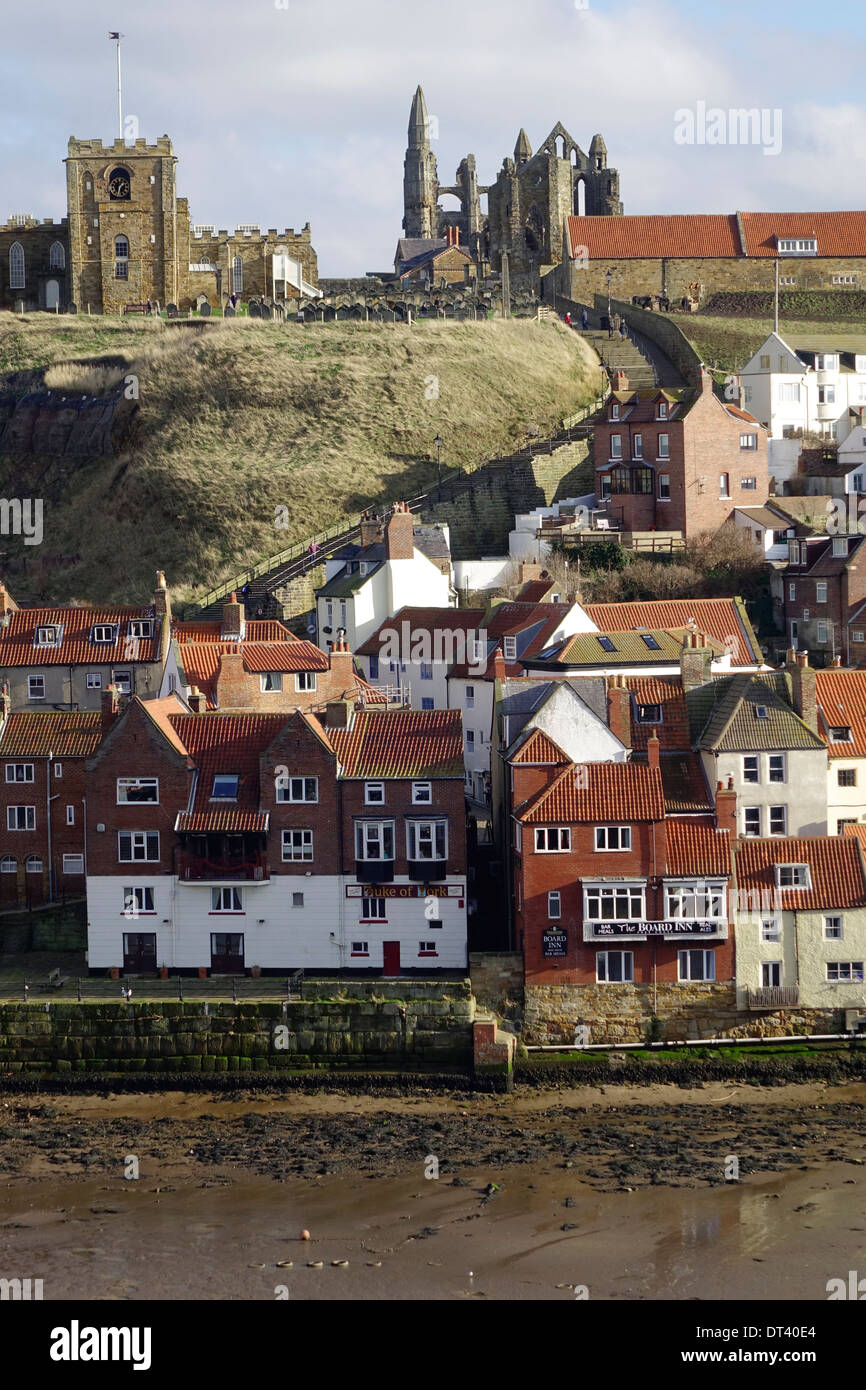Whitby harbour with cottages on the east side of town and people ...
