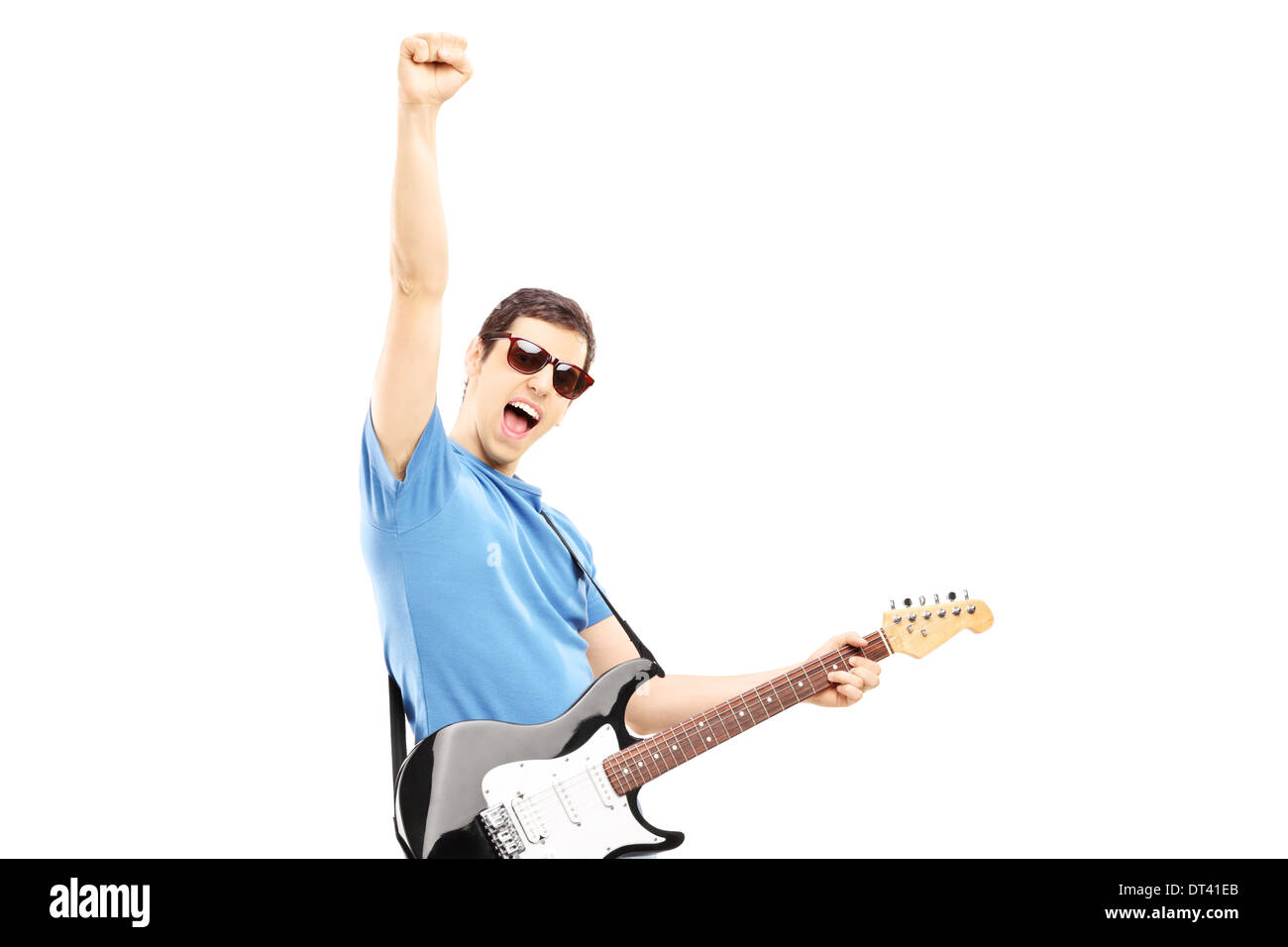 Happy guy playing on an electric guitar Stock Photo - Alamy