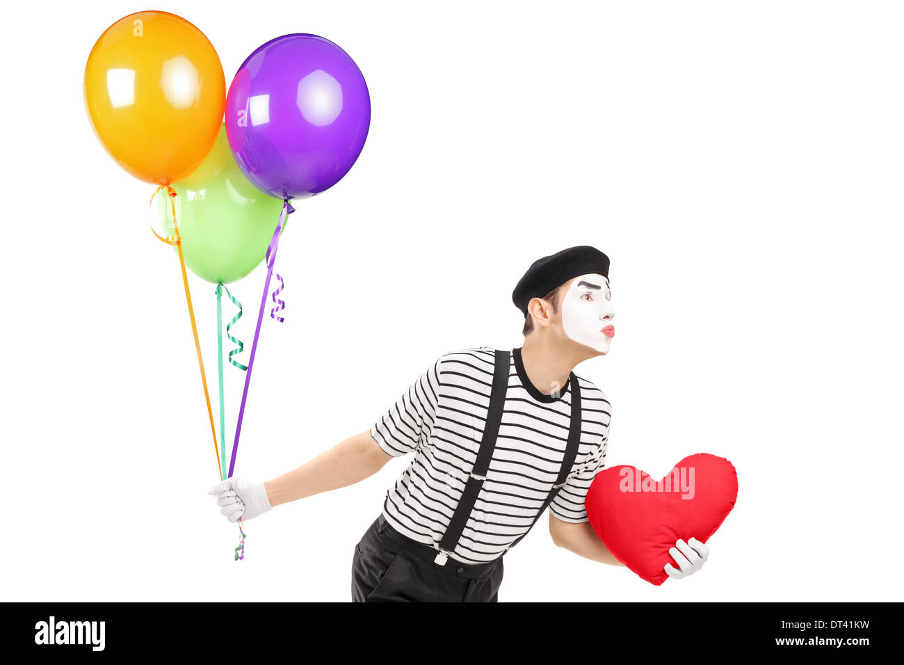 Young mime artist with balloons and red heart giving kisses Stock Photo ...