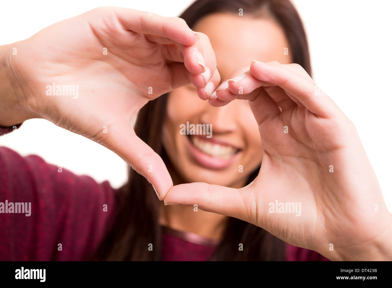Asian woman making a heart shape with her hands, isolated over white ...