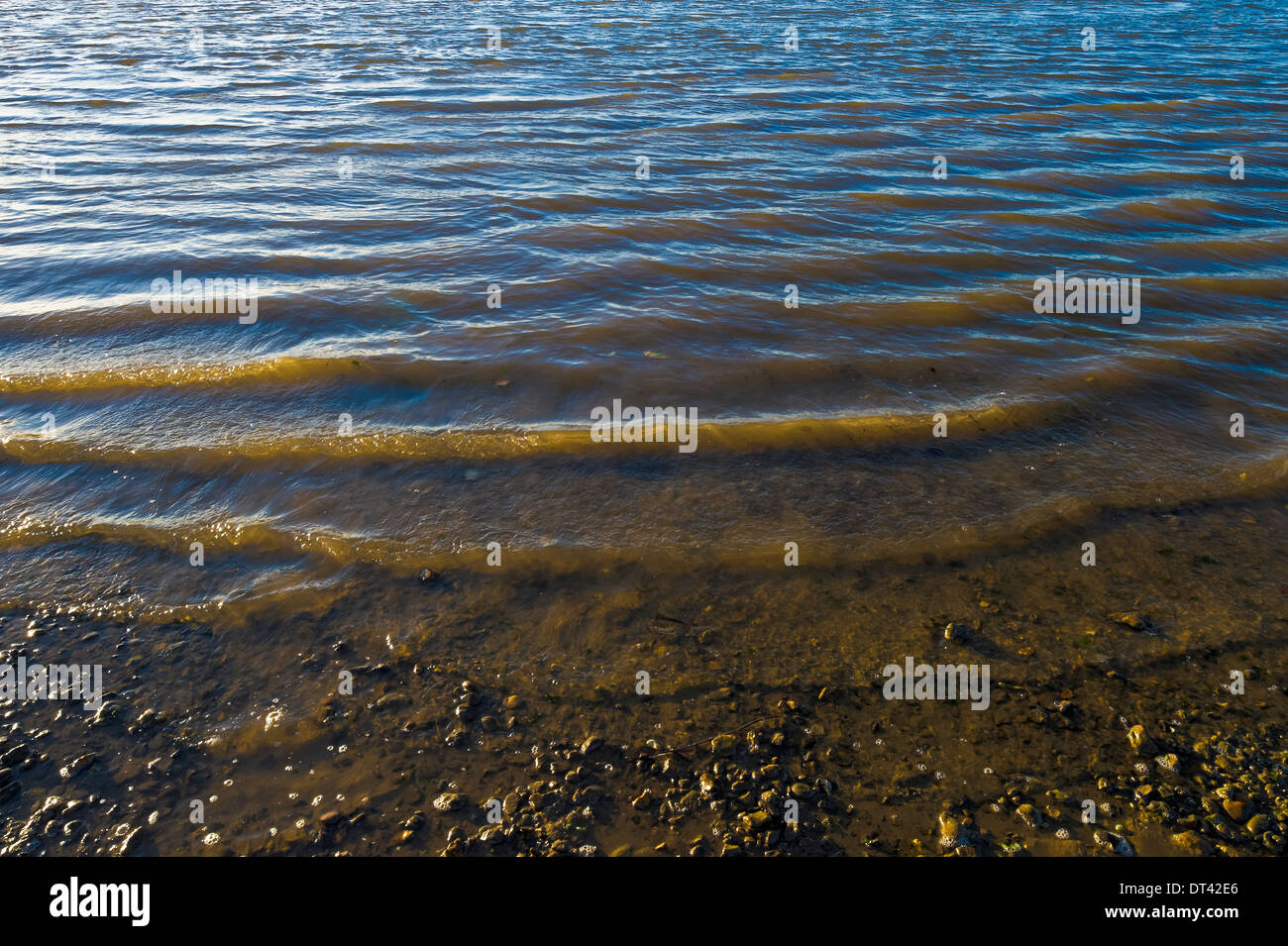 beach coastal harbour with ripples and waves Stock Photo - Alamy