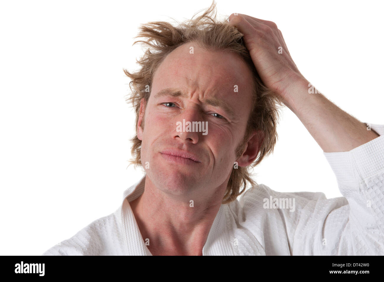 Man waking up confused on white background Stock Photo - Alamy