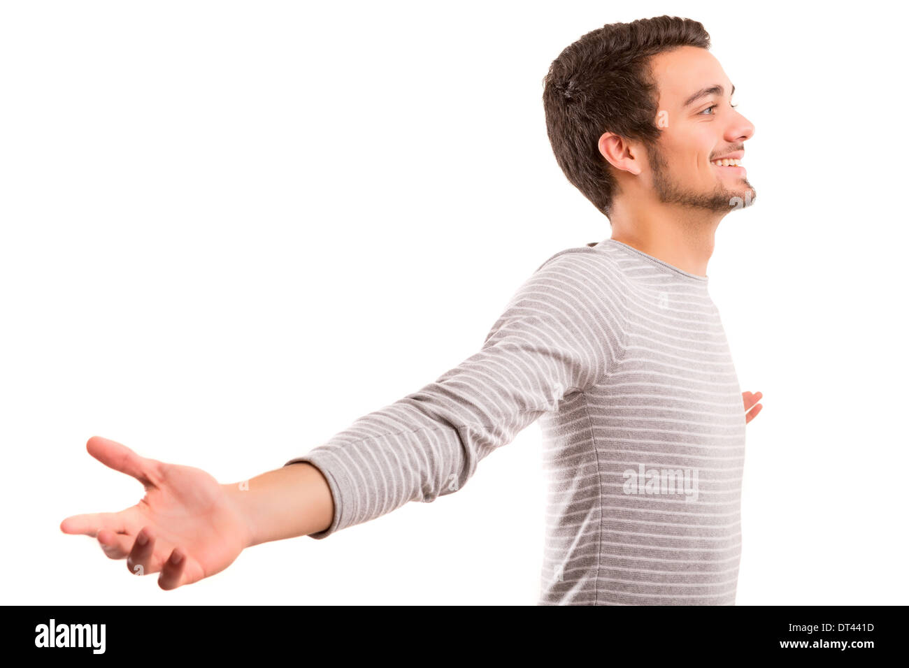 Happy young man celebrating with arms open Stock Photo - Alamy