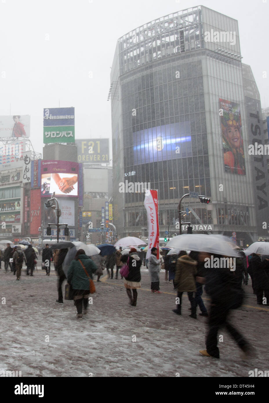 Tokyo, Japan. 8th Feb, 2014. Pedestrians holding umbrellas walk in snow ...