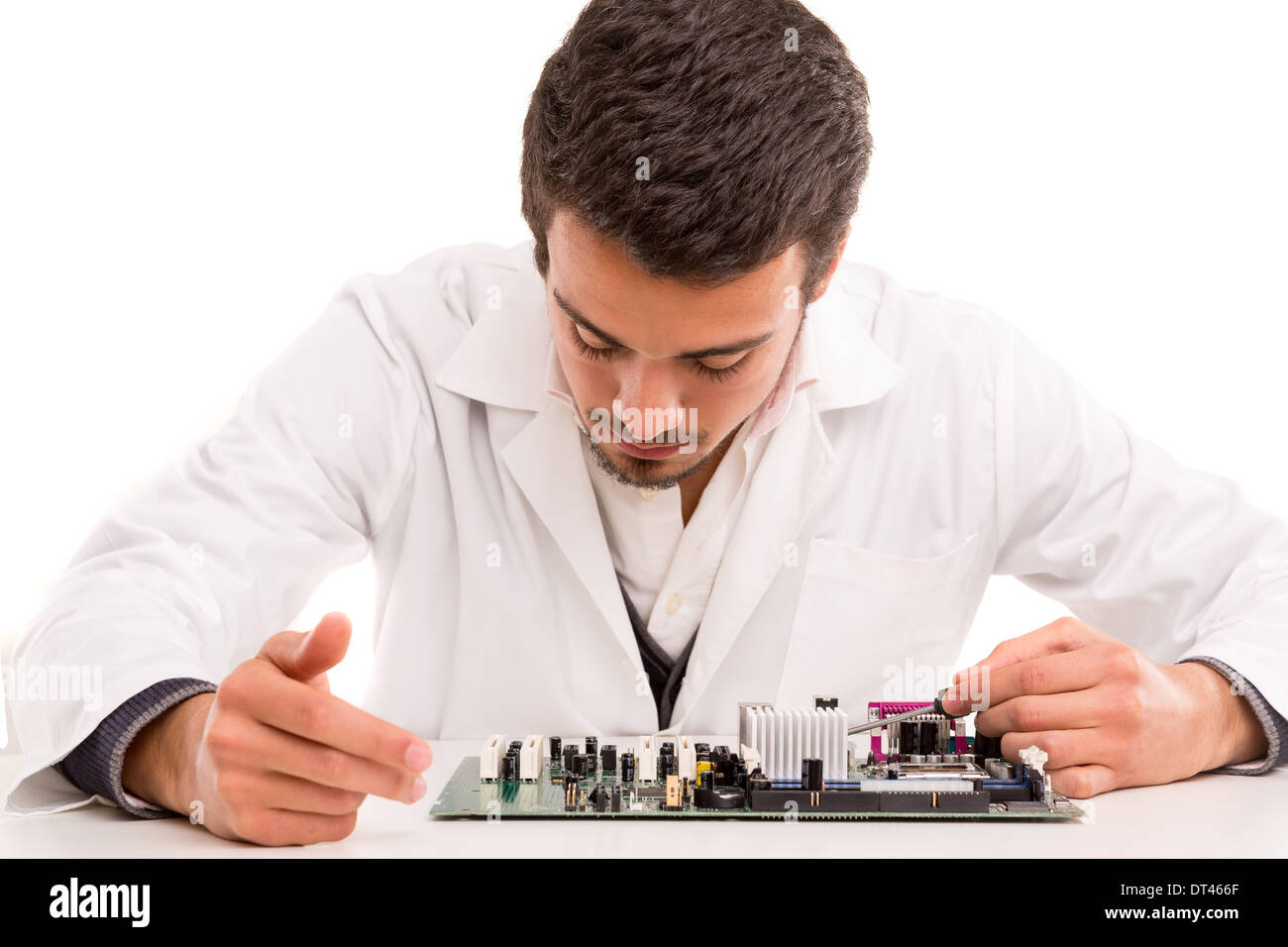 A computer engineer or technician, working on a computer motherboard ...