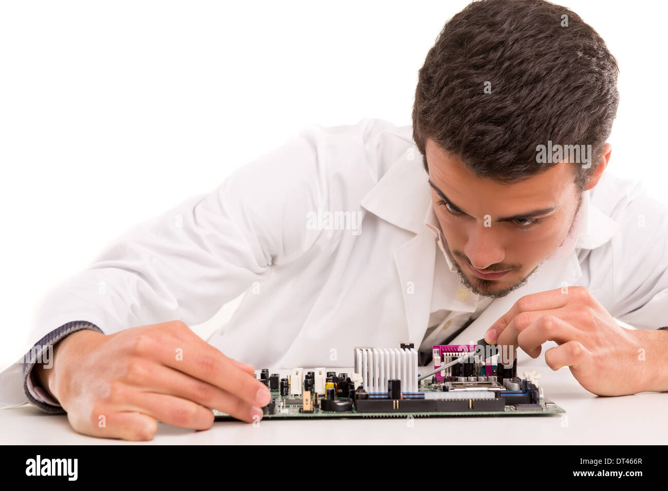 A computer engineer or technician, working on a computer motherboard ...