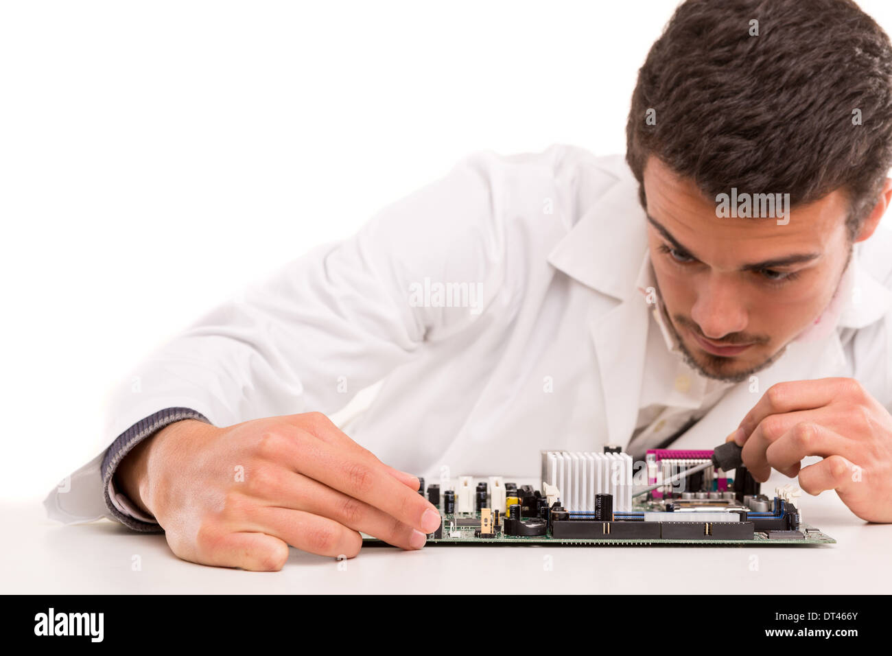 A computer engineer or technician, working on a computer motherboard ...