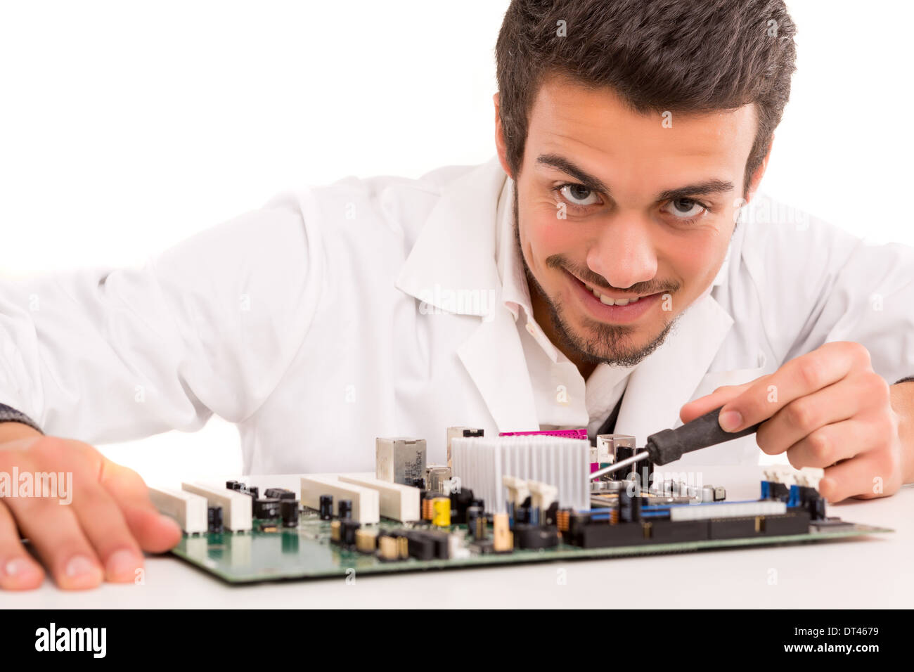 A computer engineer or technician, working on a computer motherboard ...