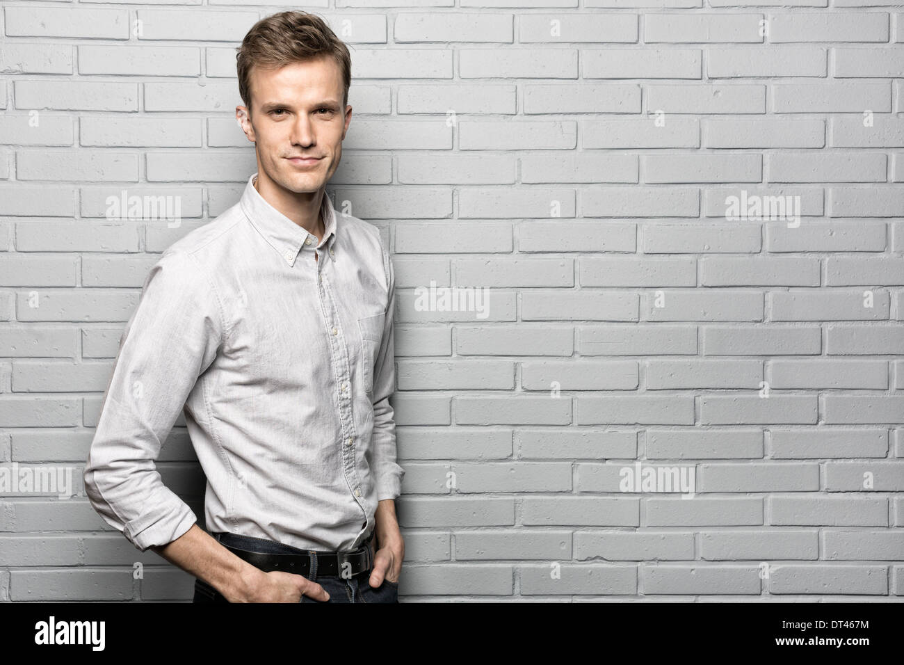 Male casual portrait smiling studio brick looking camera Stock Photo ...