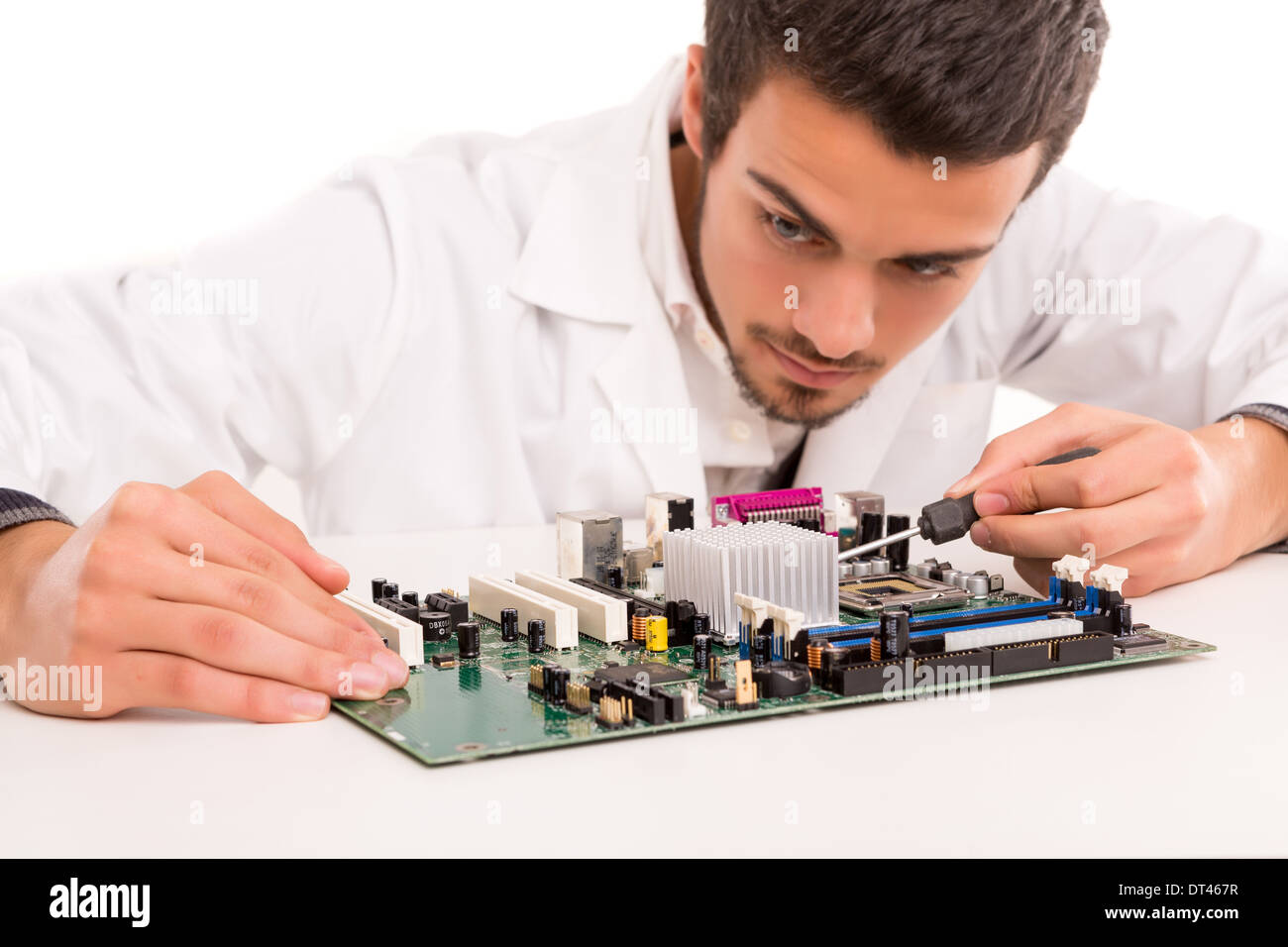 A computer engineer or technician, working on a computer motherboard ...