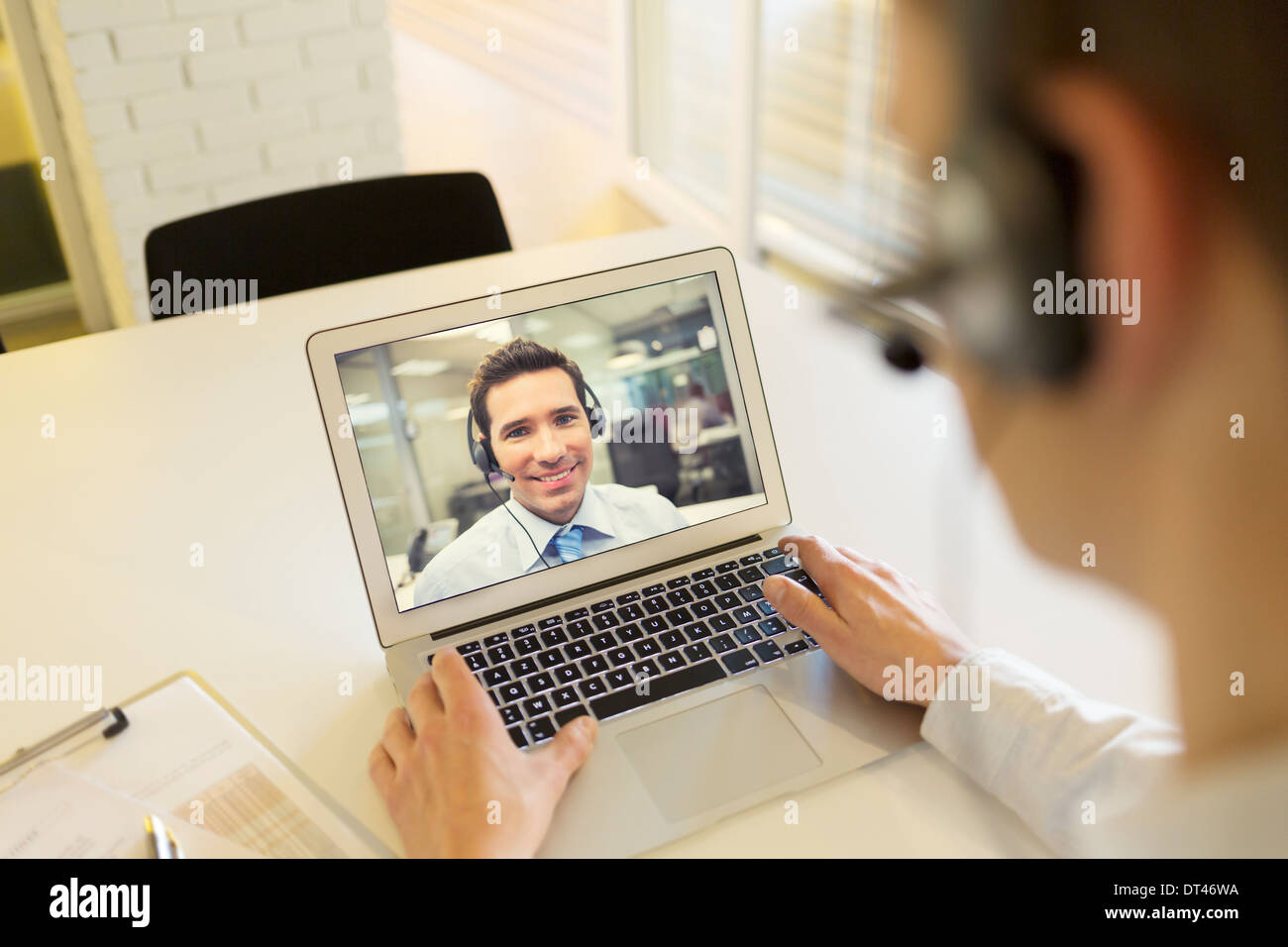 Male calling computer desk video phone Stock Photo - Alamy