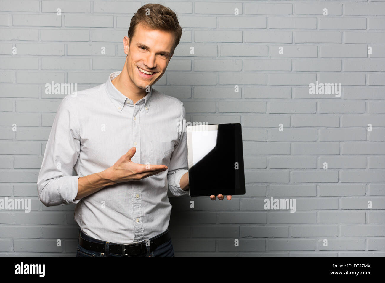 Male computer pointing studio backgroung grey looking camera Stock ...