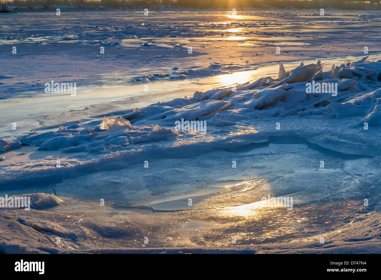 Sun Reflection on The Icy River during the sunrise Stock Photo - Alamy