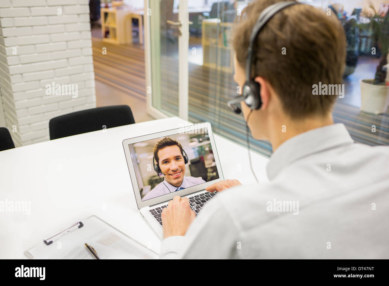 Male calling computer desk video phone Stock Photo - Alamy