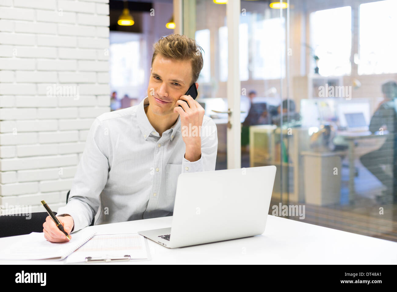 Professional man sitting desk reading hi-res stock photography and ...